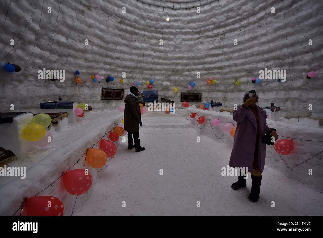 Indian tourists take their photos inside an "Igloo Cafe", a cafe ...