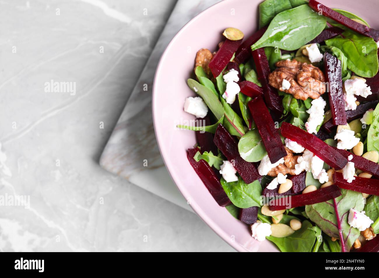 Delicious beet salad served on grey marble table, top view. Space for ...