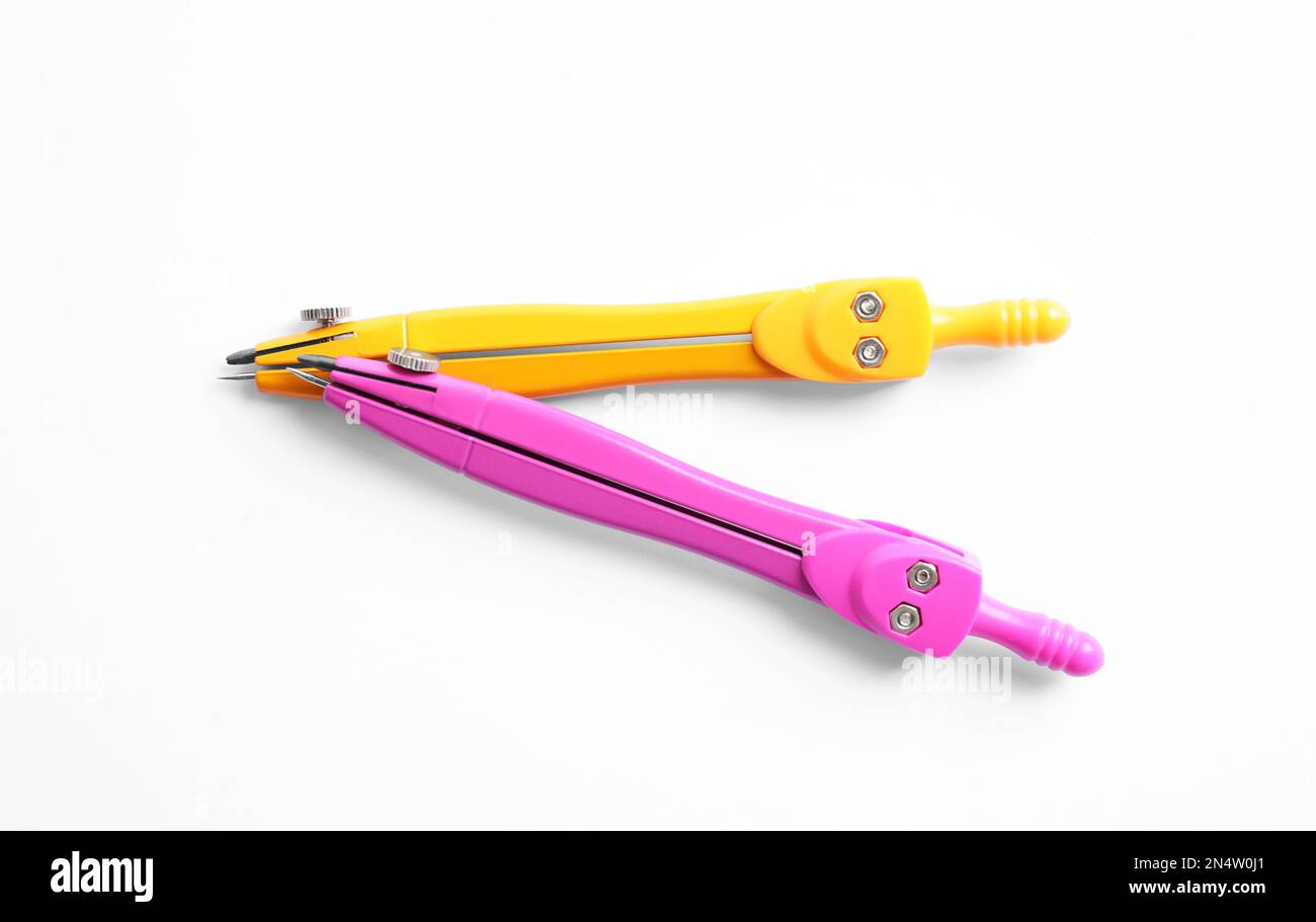 Colorful compasses on white background, top view. School stationery ...