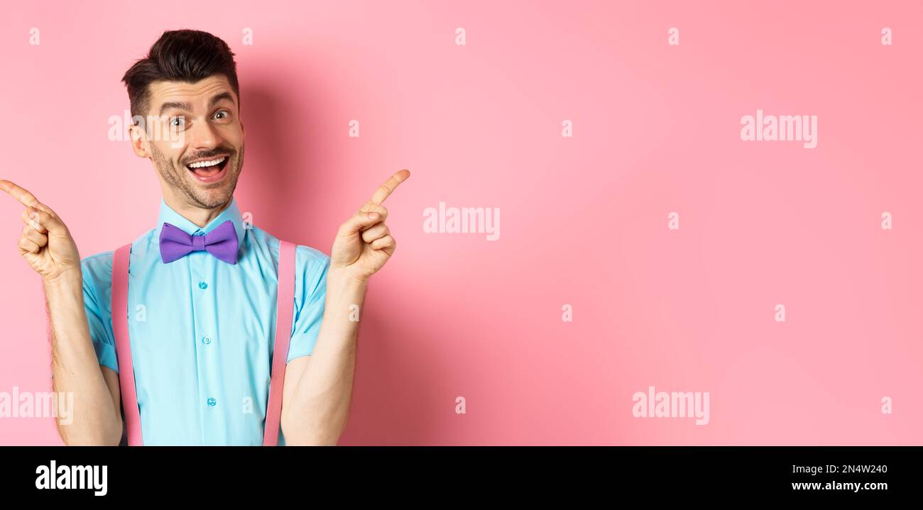 Handsome funny guy pointing fingers aside, showing left and right logo ...