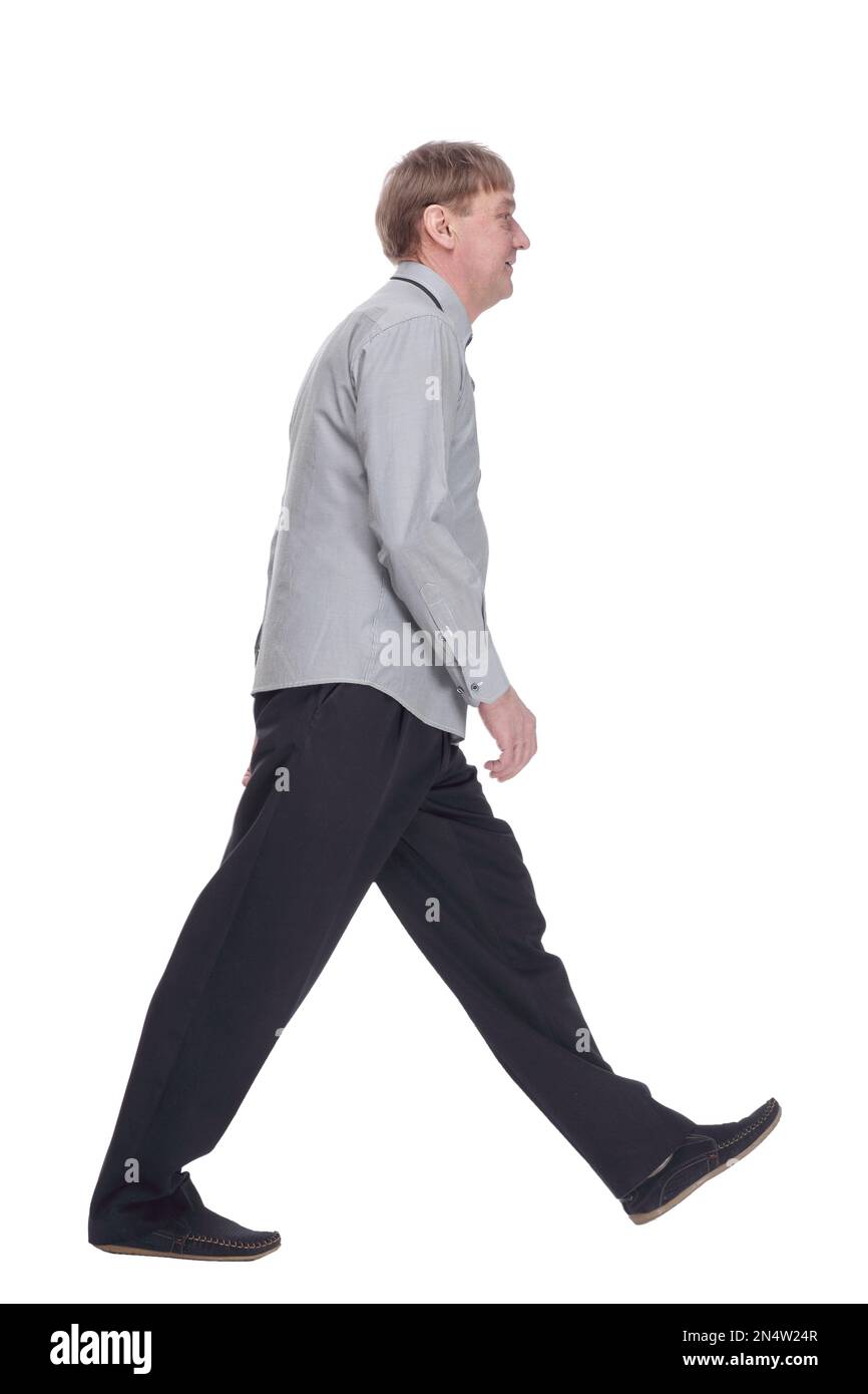confident mature man in a white shirt striding forward Stock Photo - Alamy