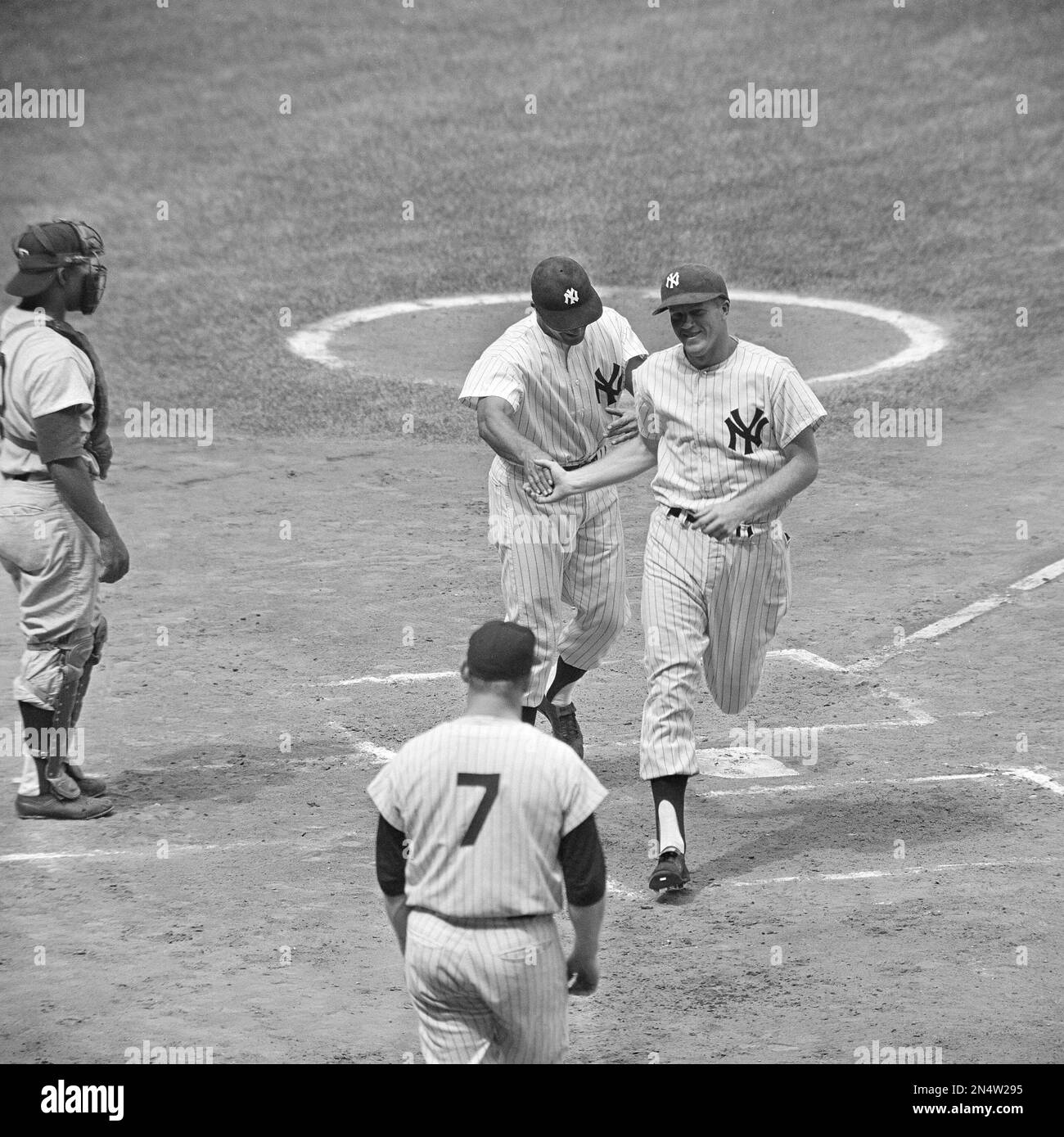 Tony Kubek of the New York Yankees, is greeted at home plate after ...