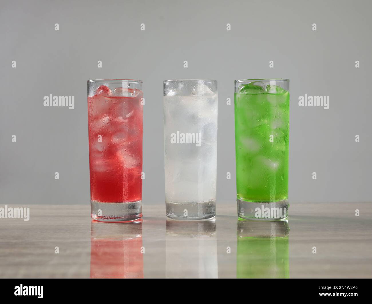 Delicious refreshing drinks in glasses on grey table Stock Photo - Alamy