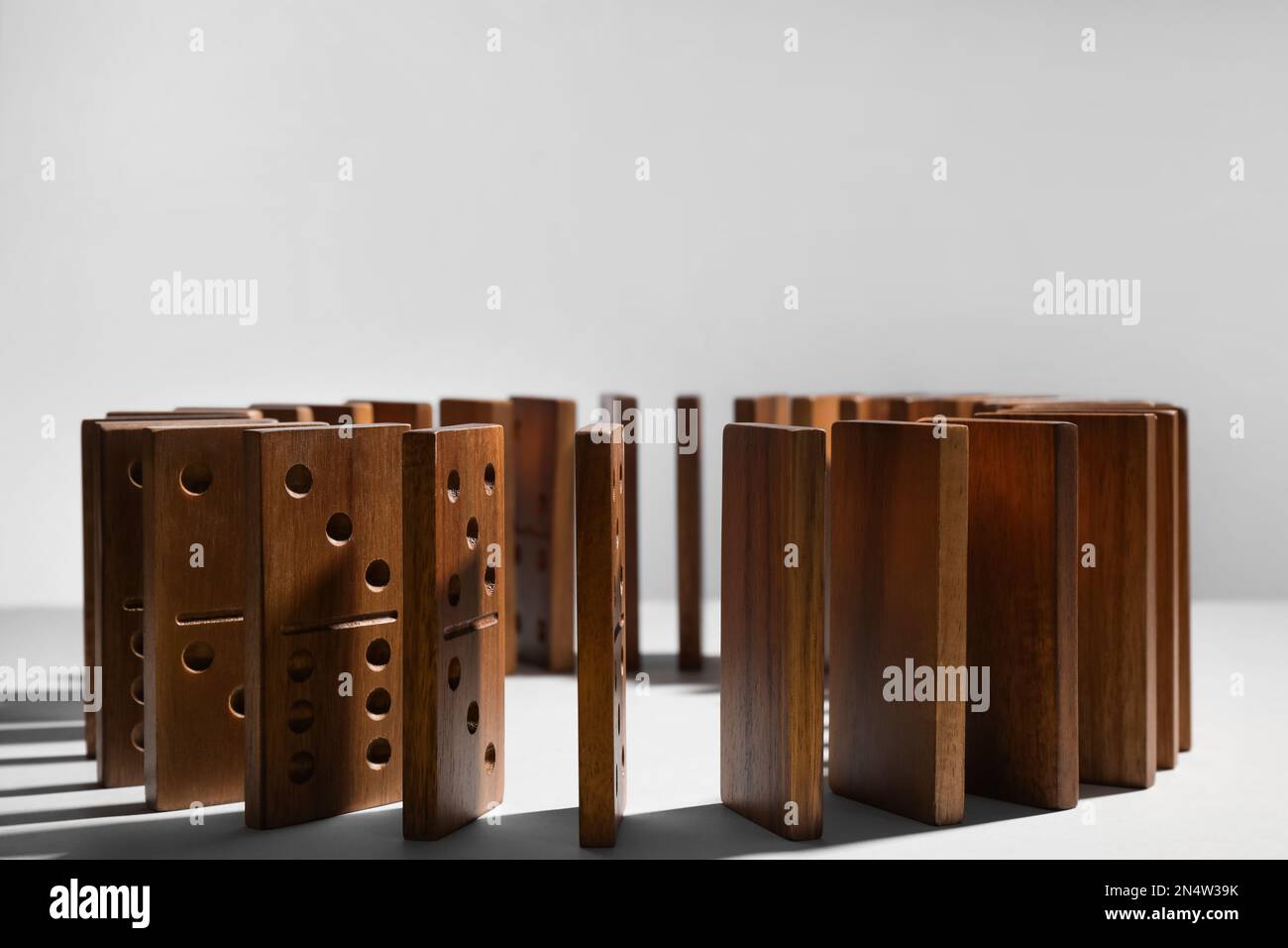 Wooden domino tiles with pips on light grey background Stock Photo - Alamy