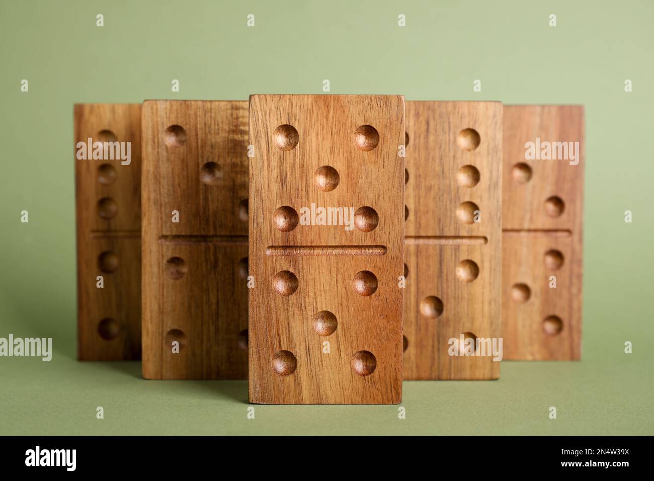 Wooden domino tiles with pips on green background Stock Photo - Alamy