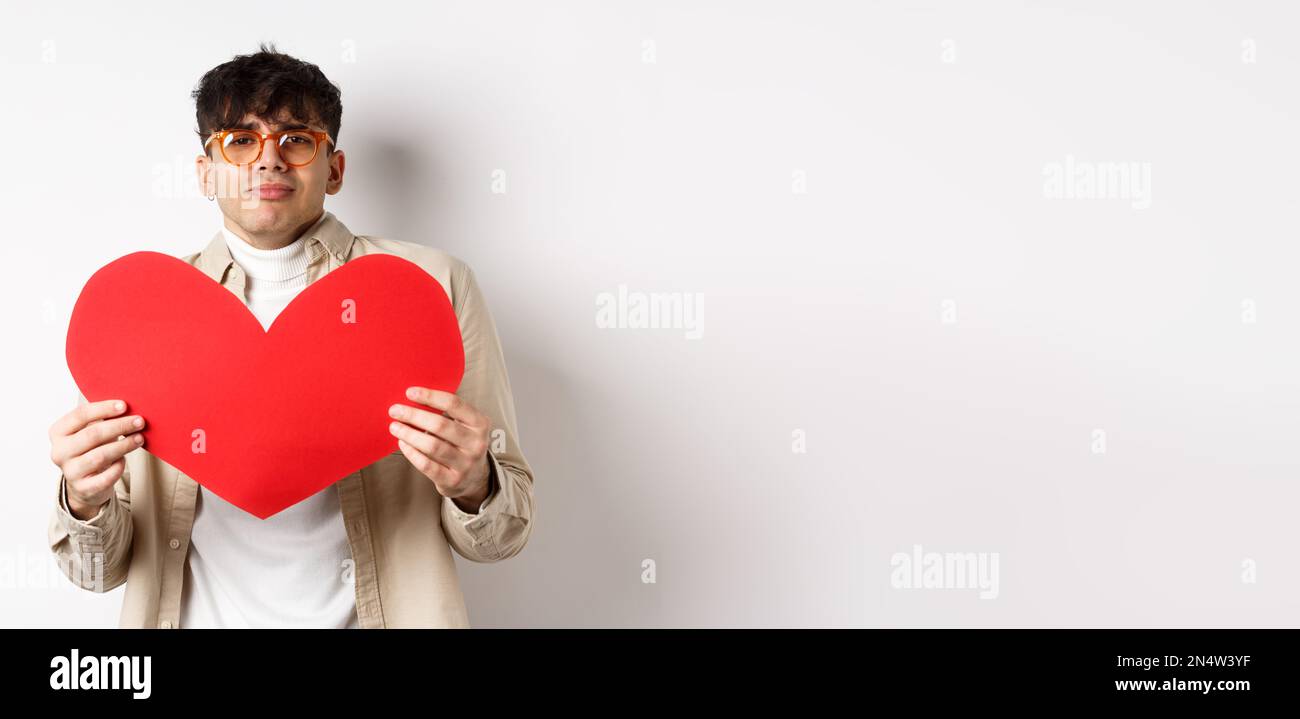 Passionate man waiting for lover with big red heart on Valentines day ...
