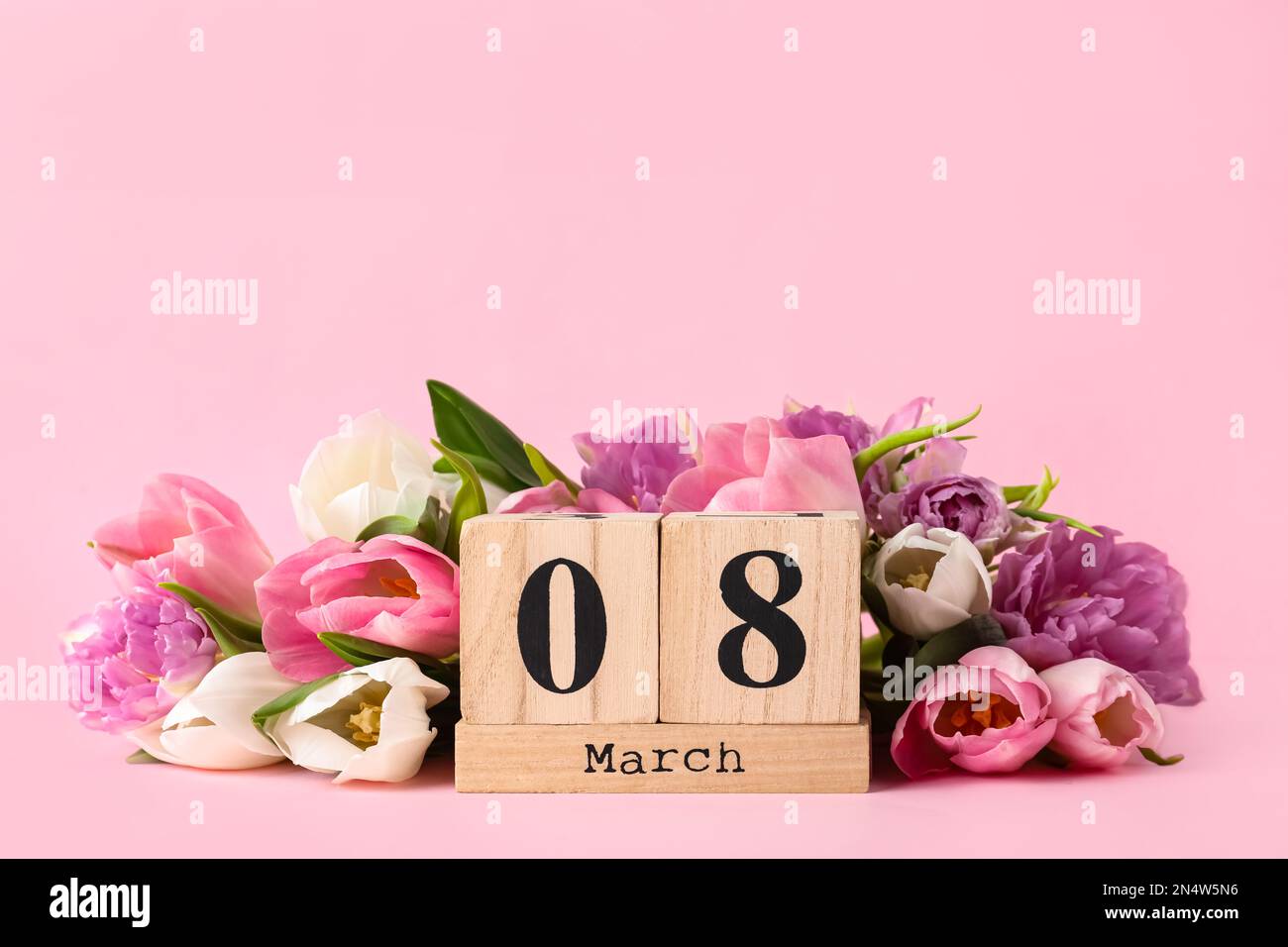 Wooden block calendar with date 8th of March and tulips on pink ...