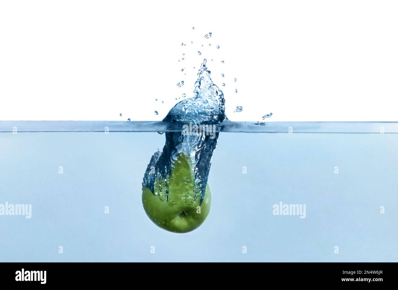 Apple falling down into clear water against white background Stock ...