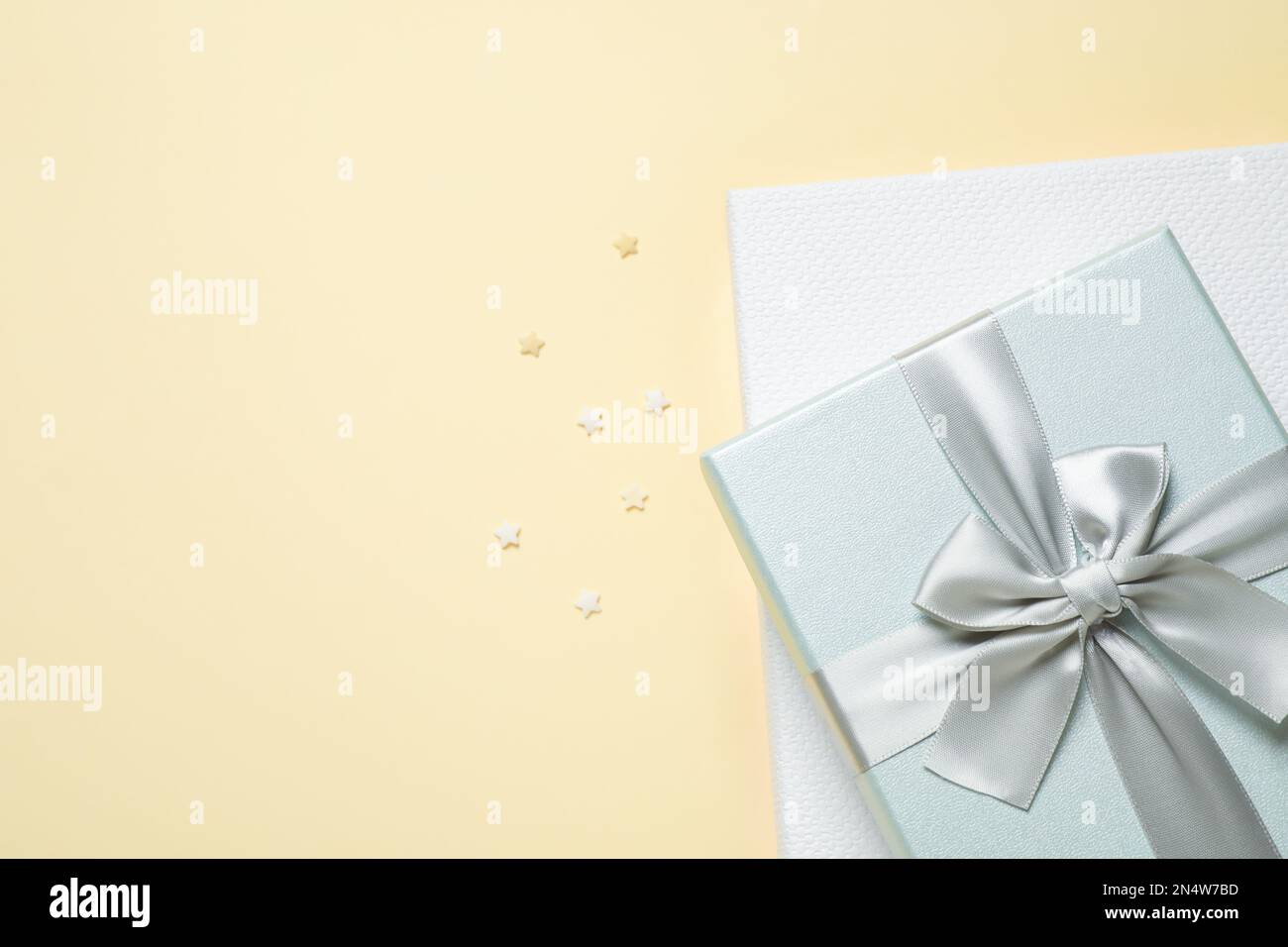 Beautiful gift boxes on beige background, top view. Space for text ...