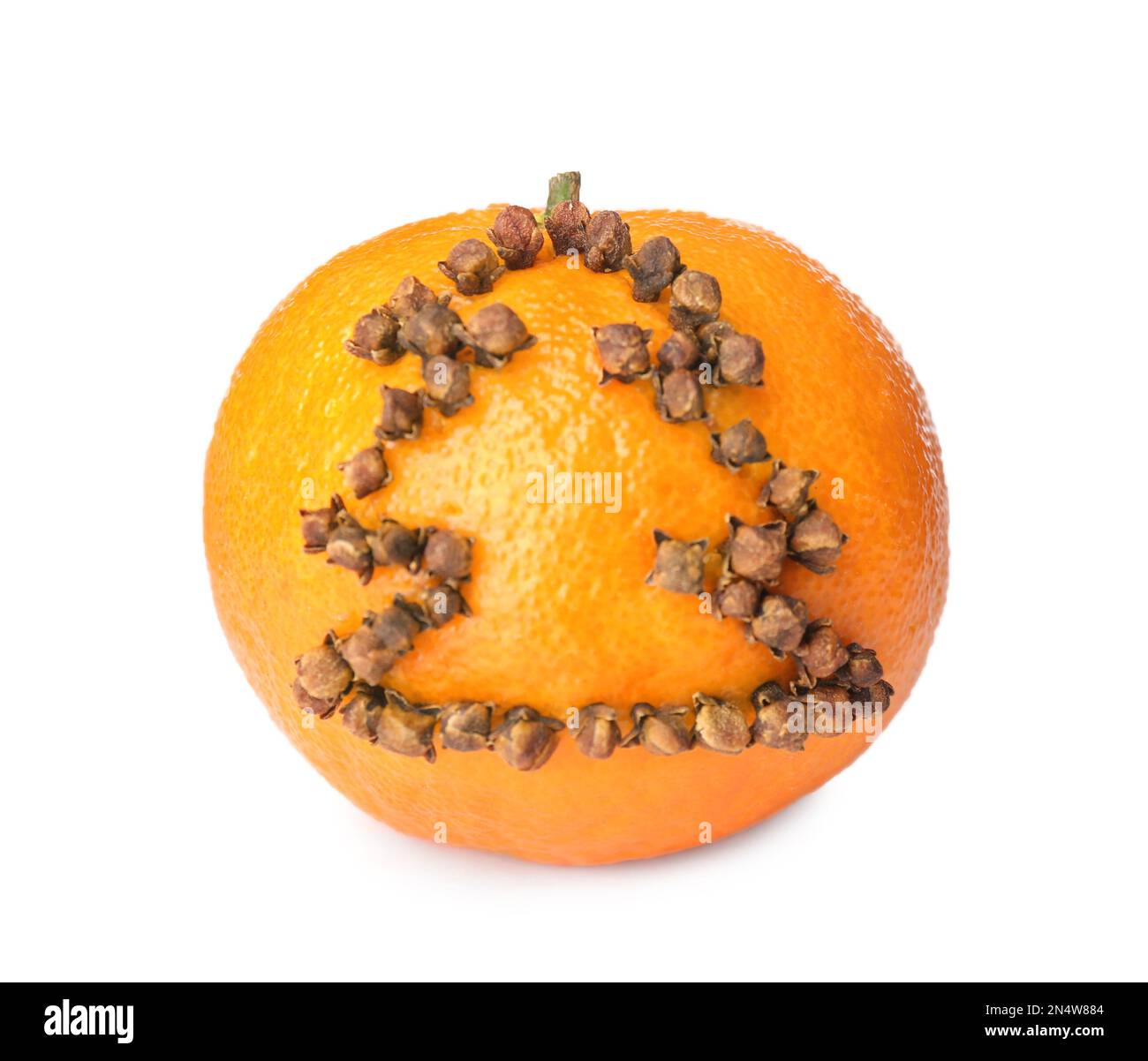Tangerine with fir tree contour made of cloves isolated on white ...