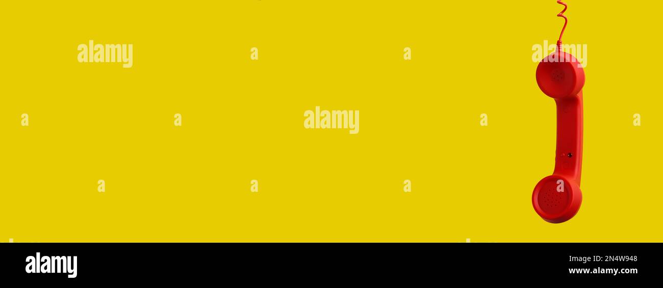 Hotline service. Red telephone receiver and space for text on yellow ...