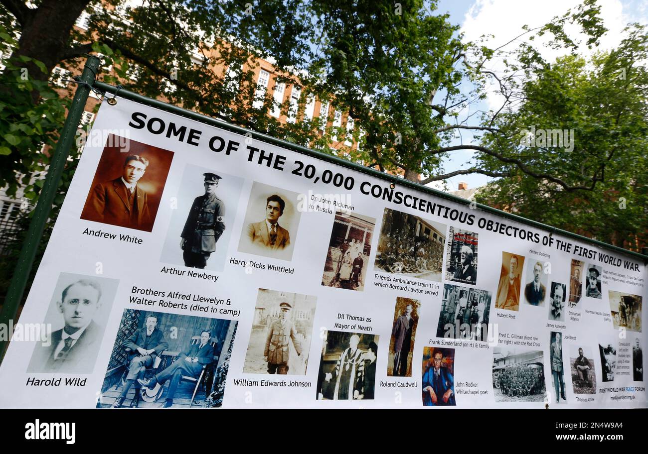 A banner with photographs of conscientious objectors hangs during a ...