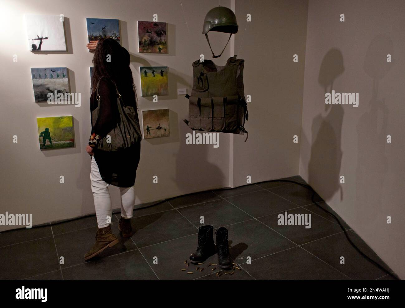 In this photo taken Saturday, May 10, 2014, a woman looks at acrylic on ...