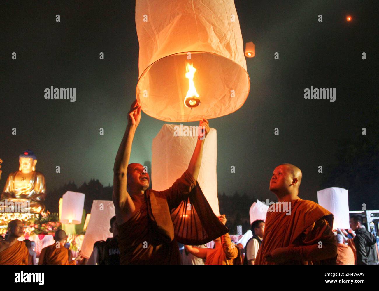 Buddhist monks fly lanterns during a celebration of Vesak day which marks the birth ...
