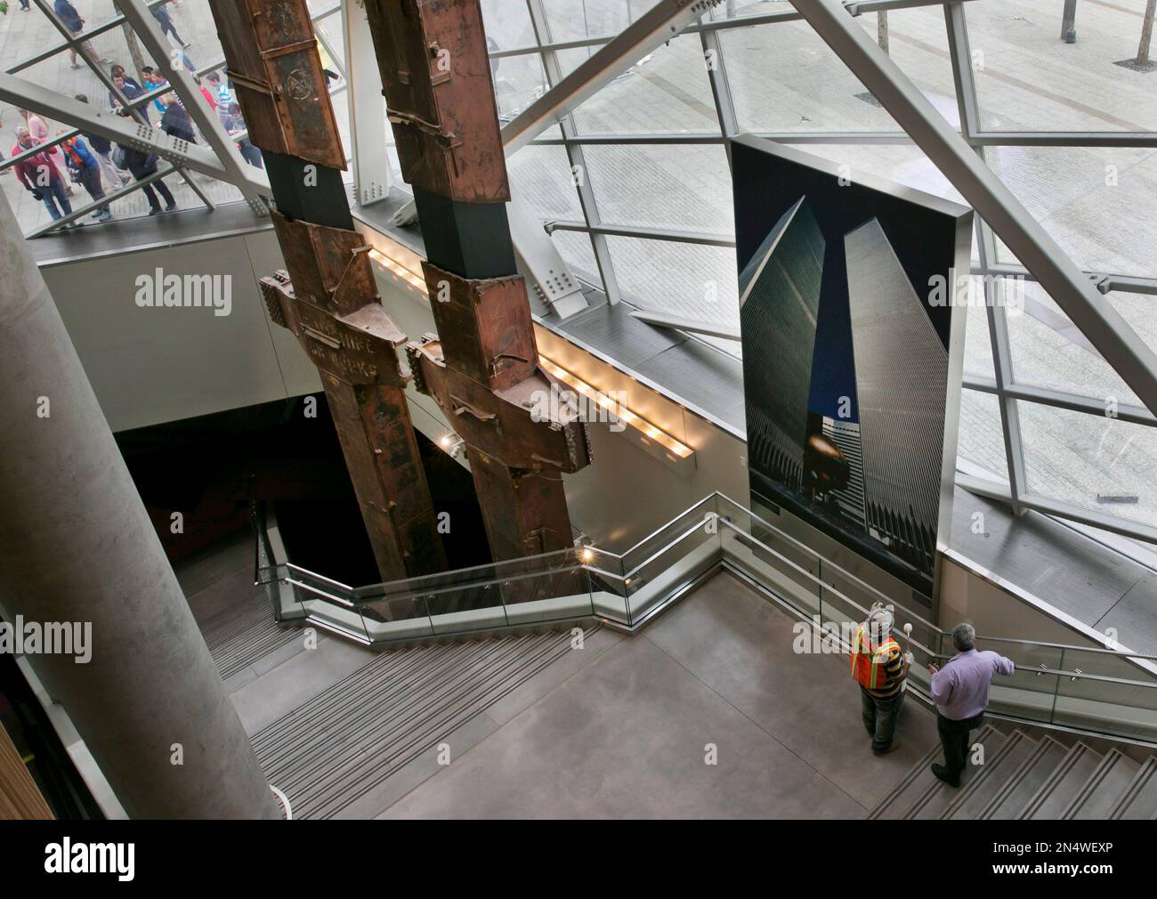 Visitors to the Sept. 11 Memorial, left, peer at pair of World Trade ...