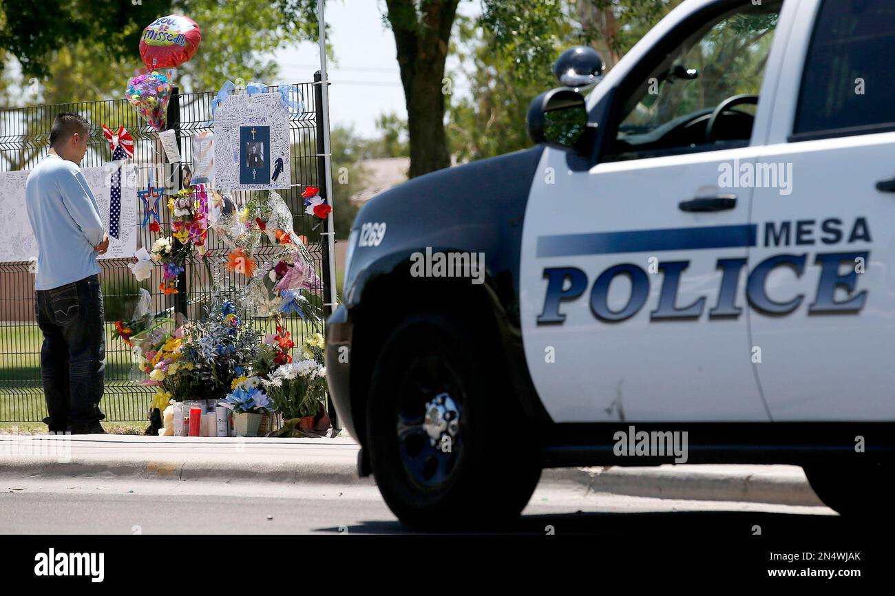 A passerby pauses at a makeshift memorial at Guerrero Park for Mesa ...
