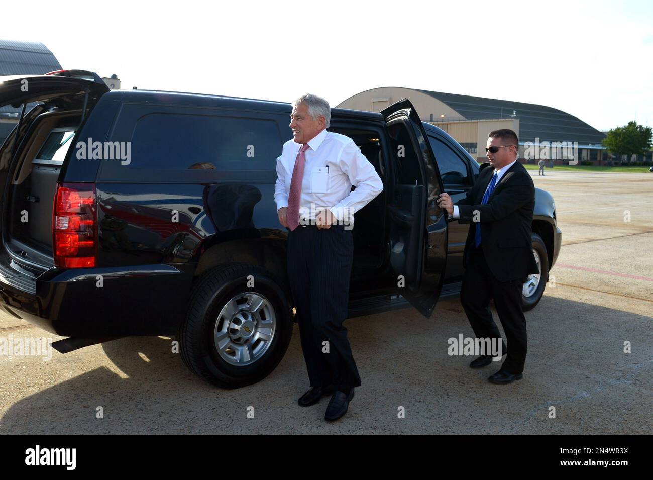 Defense Secretary Chuck Hagel arrives to board a flight at Andrews Air ...