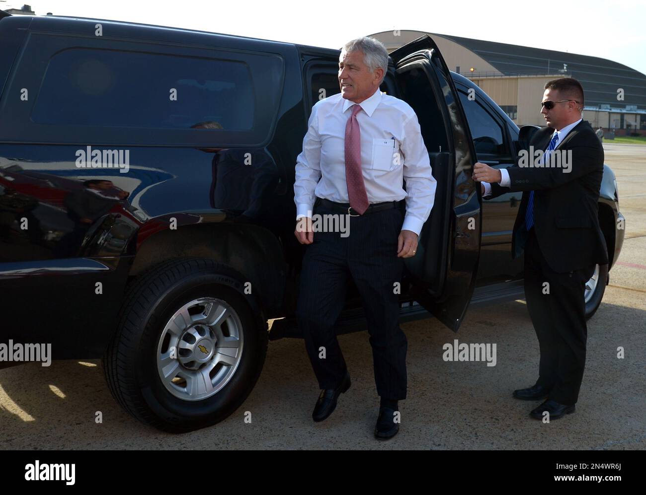 Defense Secretary Chuck Hagel arrives to board a flight at Andrews Air ...