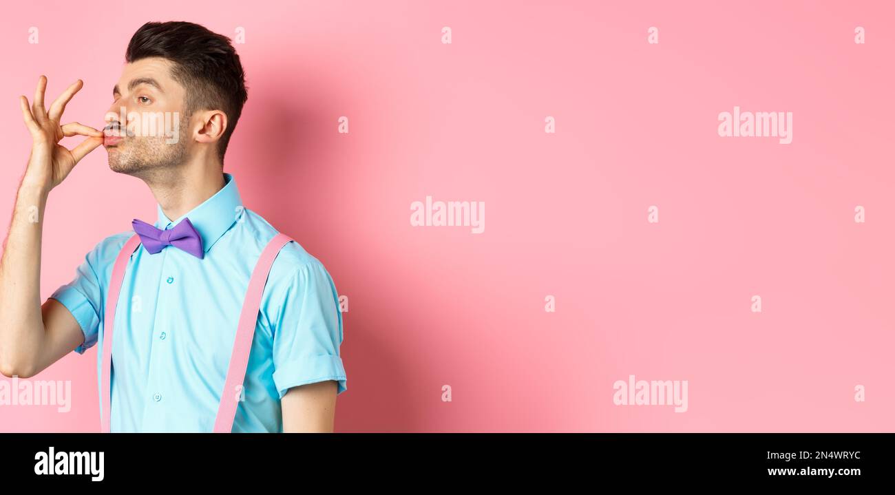 Profile of funny guy touching his french moustache and pucker lips like ...