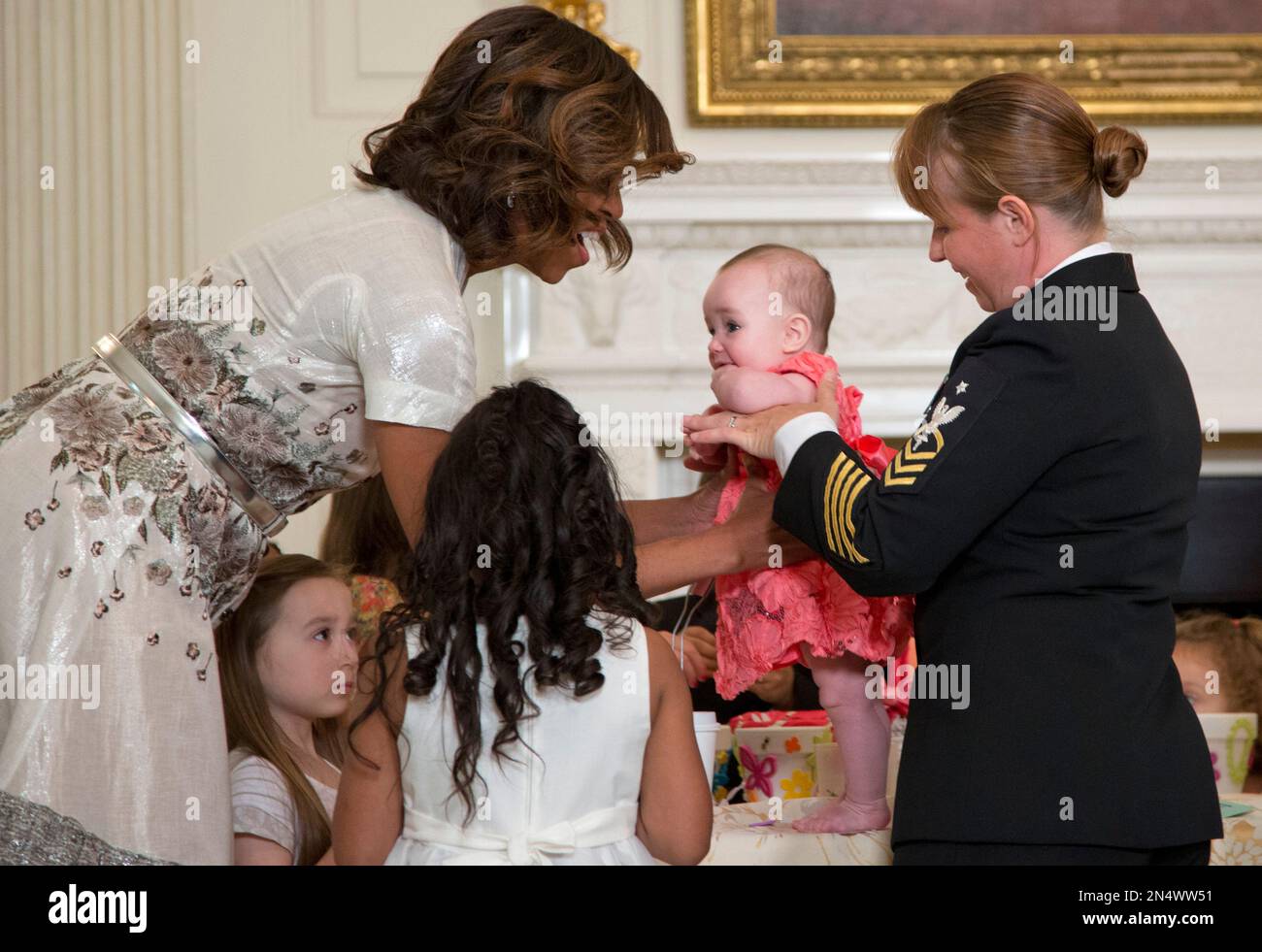 First lady Michelle Obama reaches for Avery Noelle Brindley as she ...