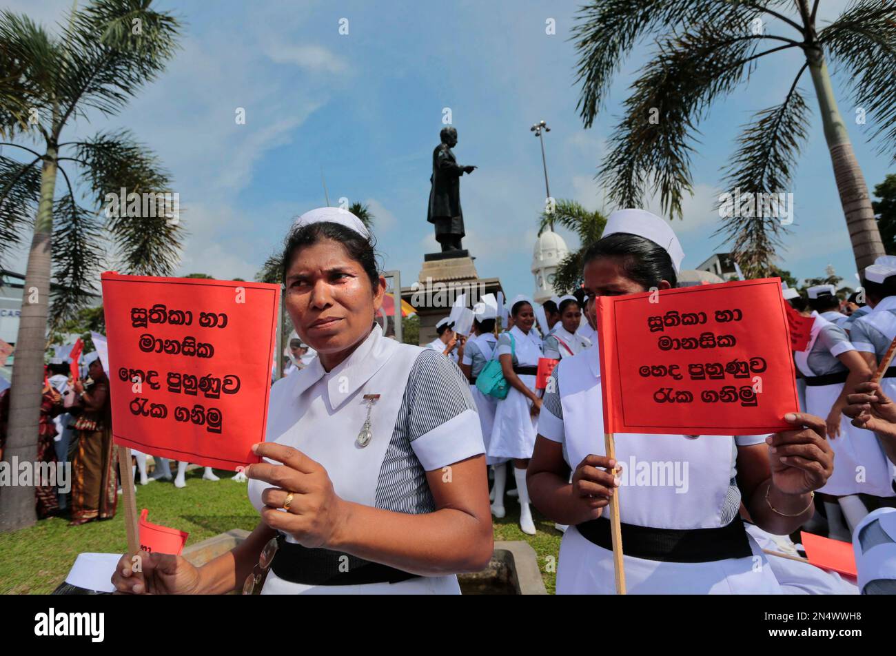 Sri Lankan nurses gather near a statue of Sri Lankan philanthropist ...