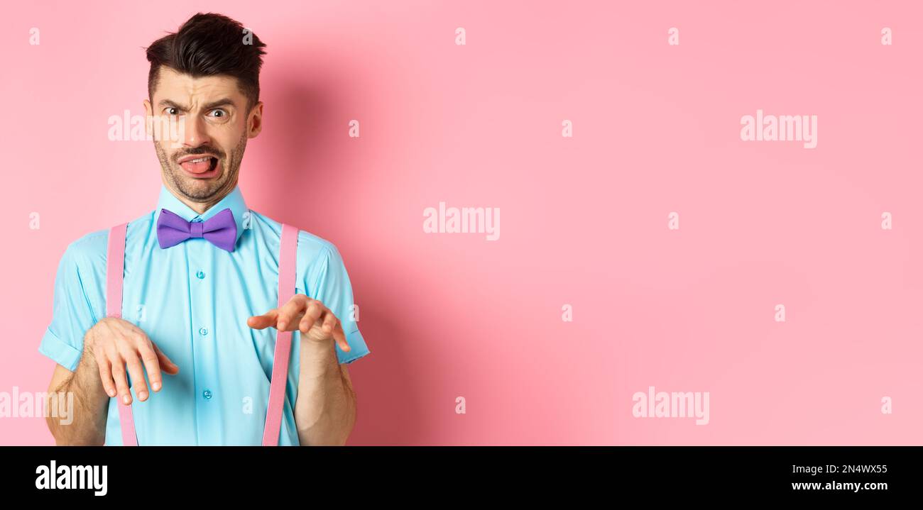 Funny guy looking at something disgusting with aversion and cringe ...