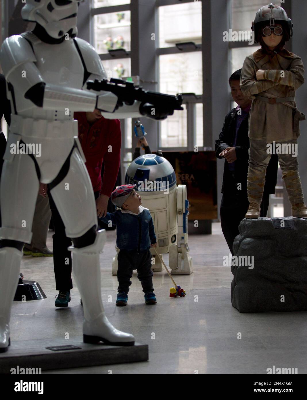 A child walks near the life-size characters figures of the Star Wars ...