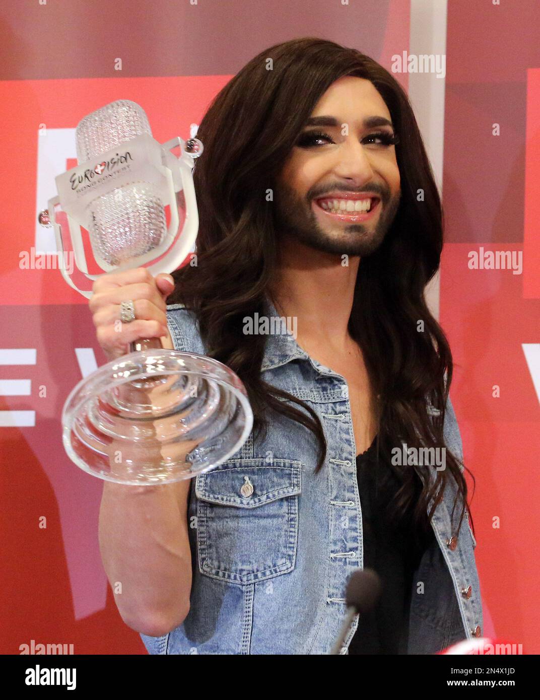 Austrian singer Conchita Wurst arrives with the trophy at the airport ...