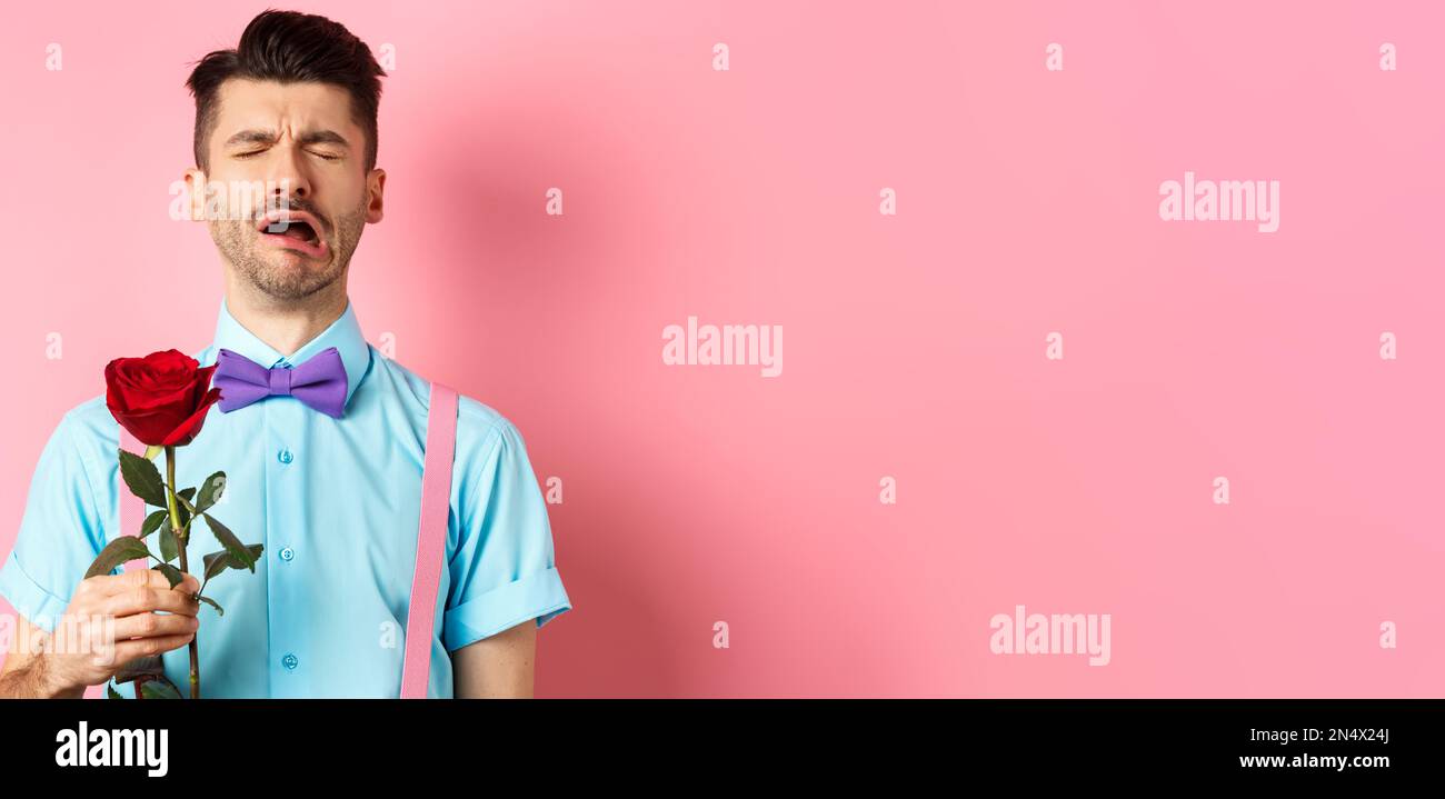 Heartbroken guy in funny bow-tie crying over girlfriend, standing alone ...
