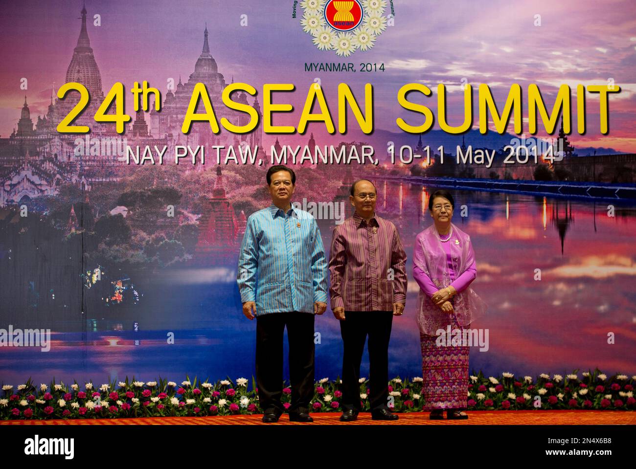 Myanmar President Thein Sein, center and his wife Khin Khin Win, right, pose for a picture with ...