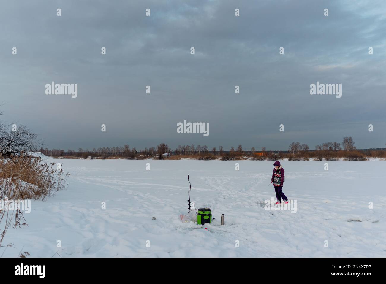Woman ice fishing hi-res stock photography and images - Alamy