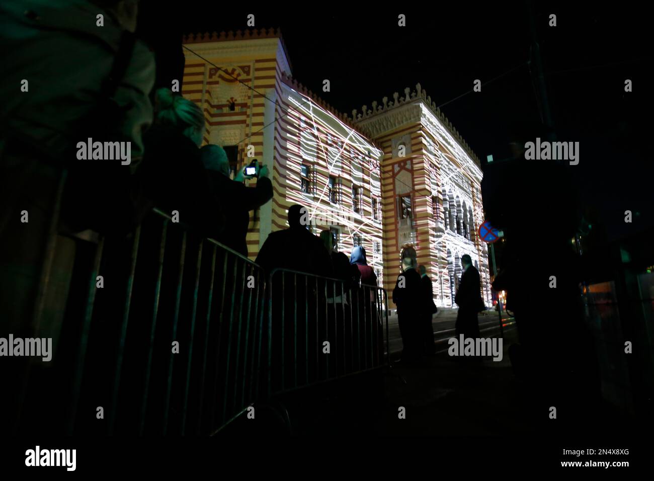 Bosnian people watching a light presentation during the opening ...