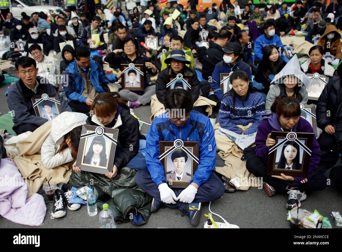 Family members holding the portraits of the victims of the sunken ferry ...