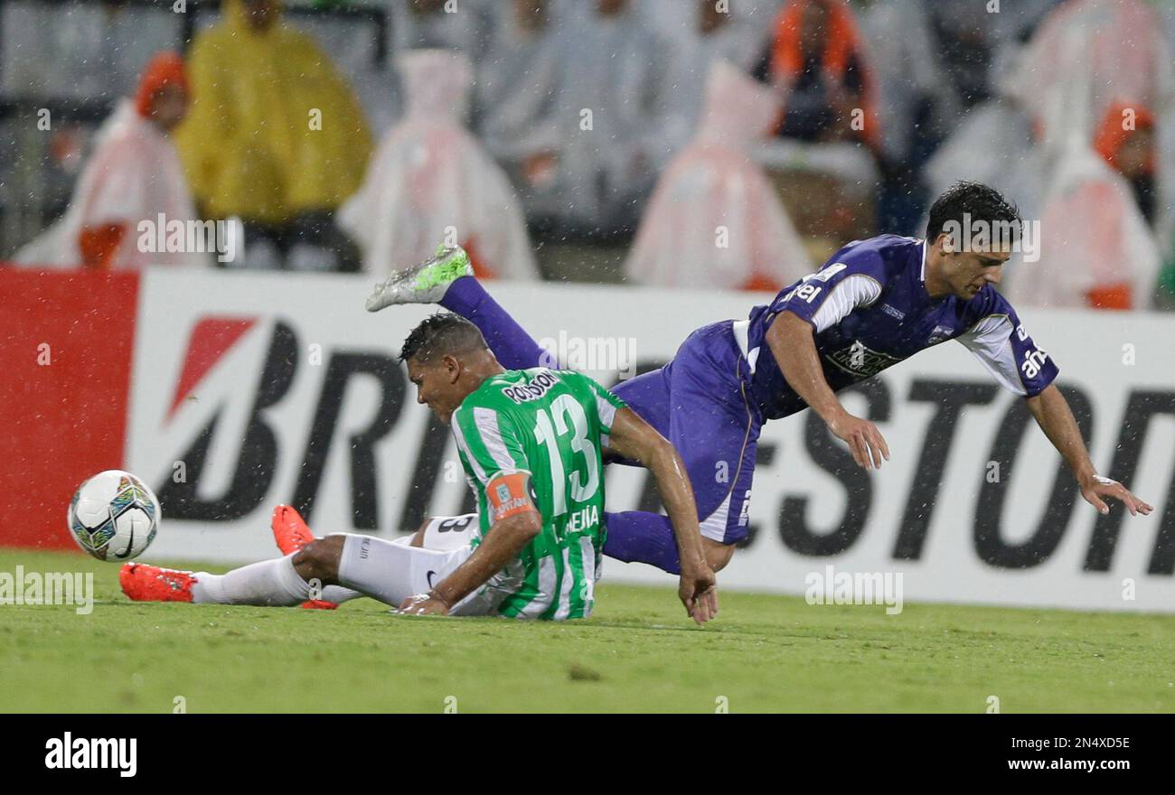 Alexander Mejia, of Colombia's Atletico Nacional, left, takes the ball ...