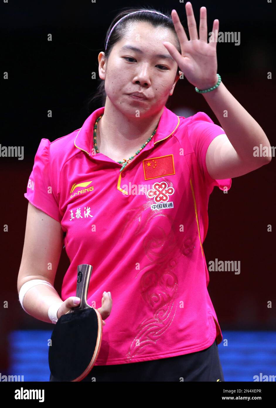 Li Xiaoxia of China gestures to her opponent Singapore's Feng Tianwei during their semifinal ...