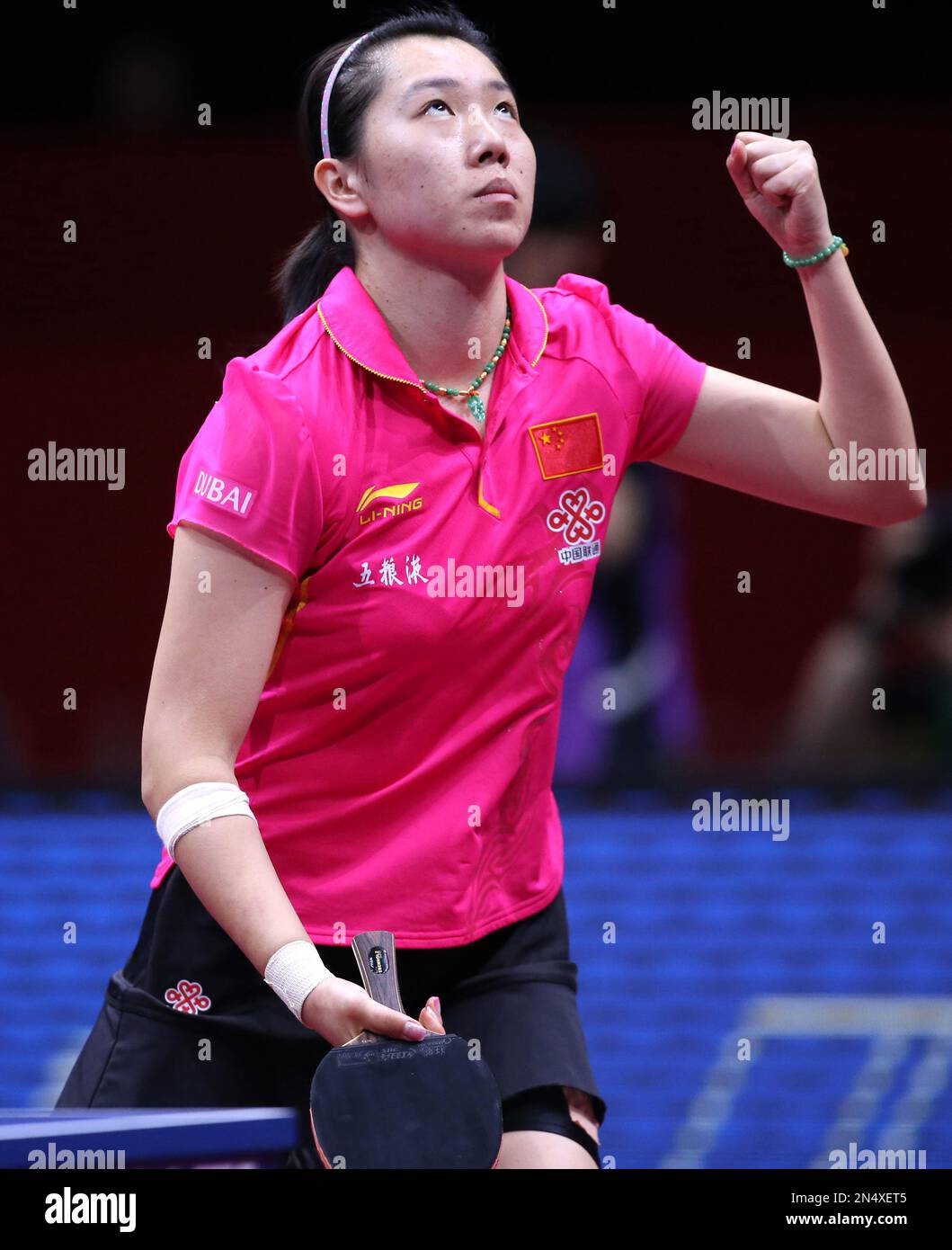 Li Xiaoxia of China reacts as she won a point against Singapore's Feng ...
