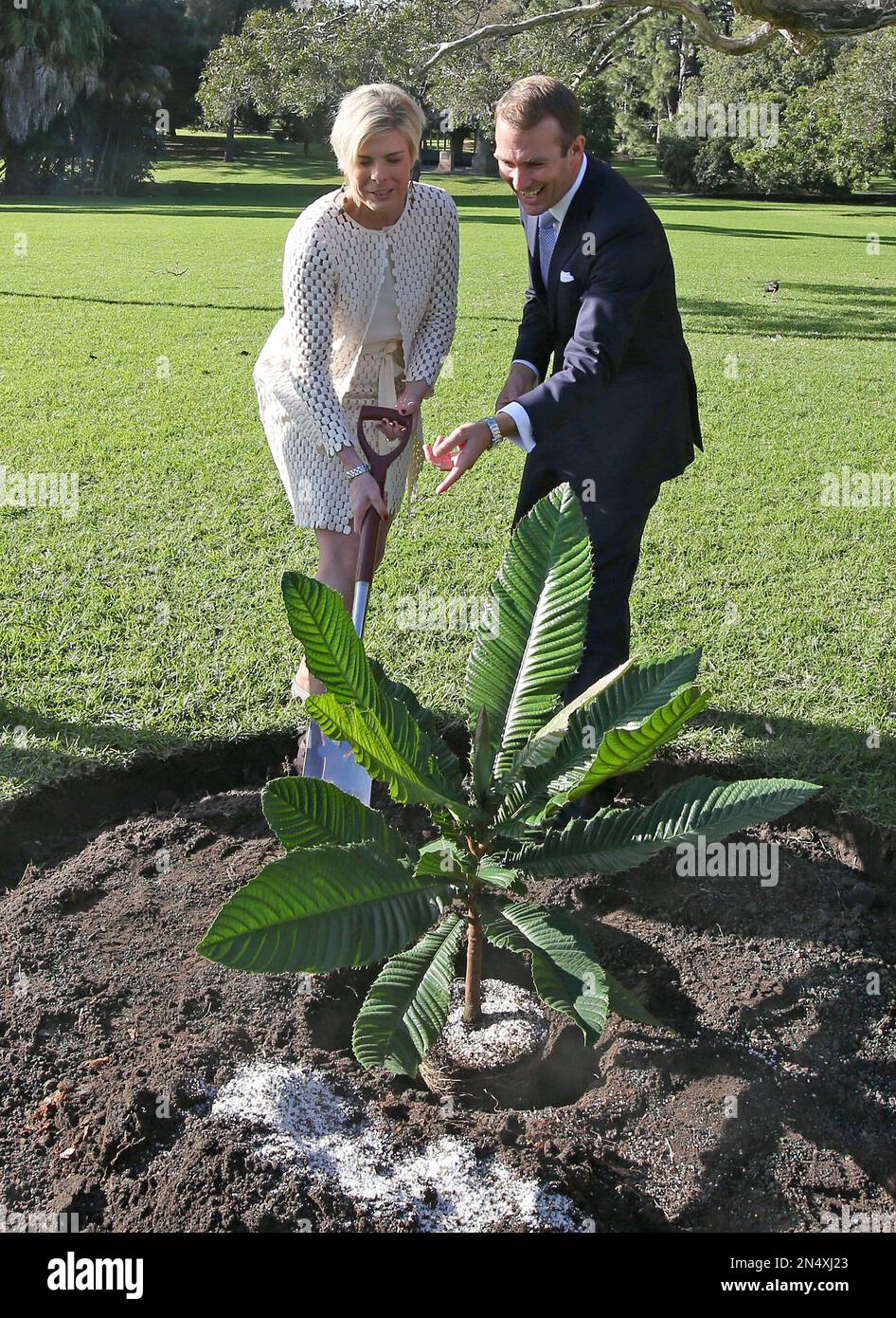 Princess Laurentien of the Netherlands, left, is assisted in planting a ...