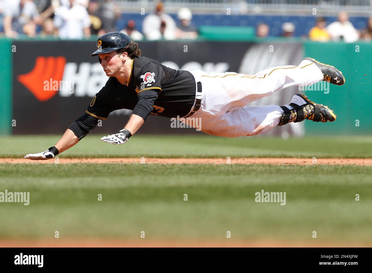 Pittsburgh Pirates' Travis Snider (23) dives for third base with a ...