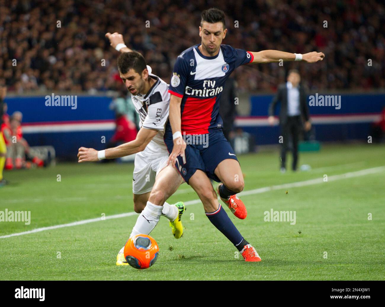 Paris Saint-Germain's Javier Pastore, right, challenges for the ball ...