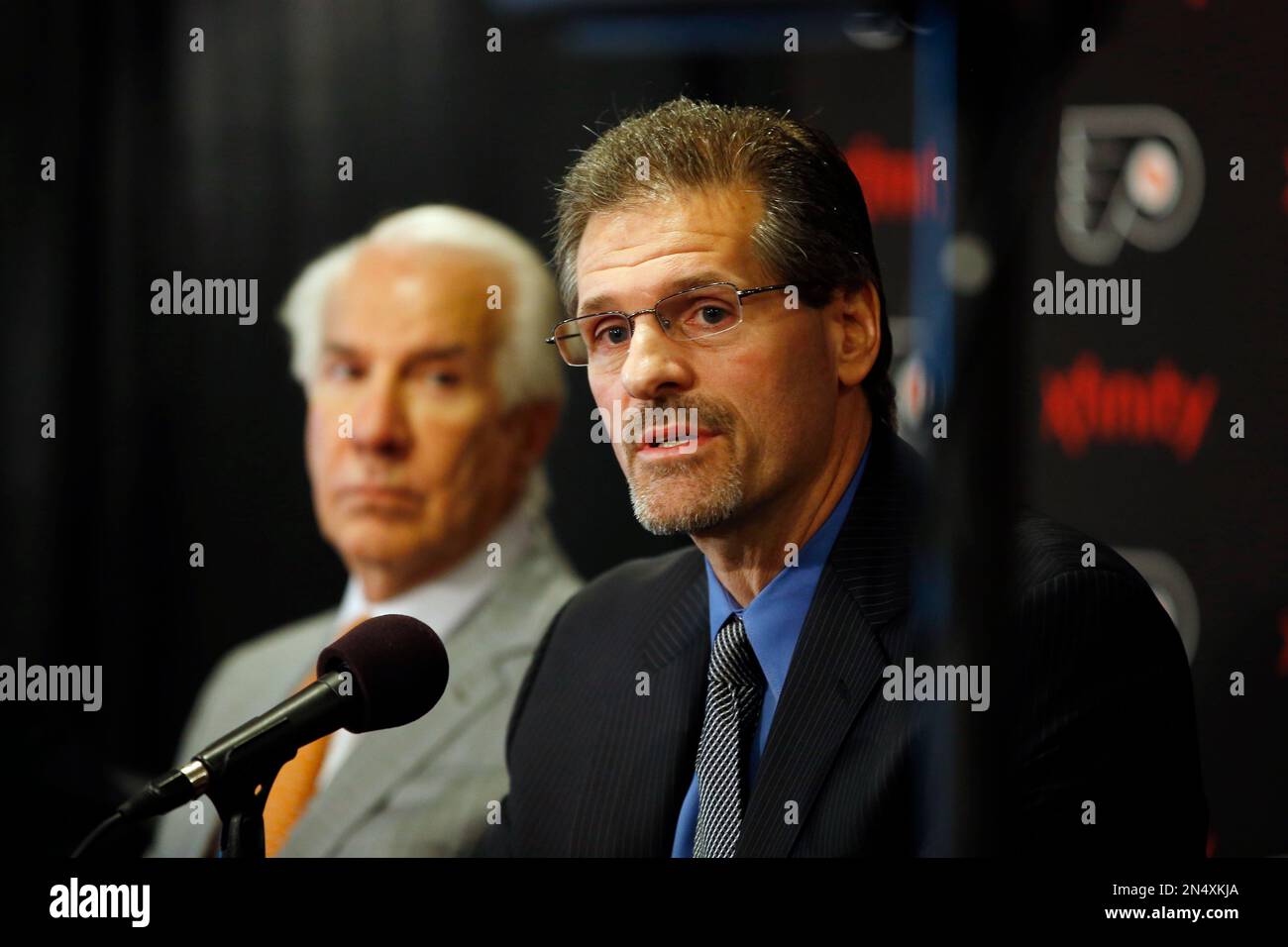 New Philadelphia Flyers general manager Ron Hextall, right, speaks as chairman Ed Snider looks ...
