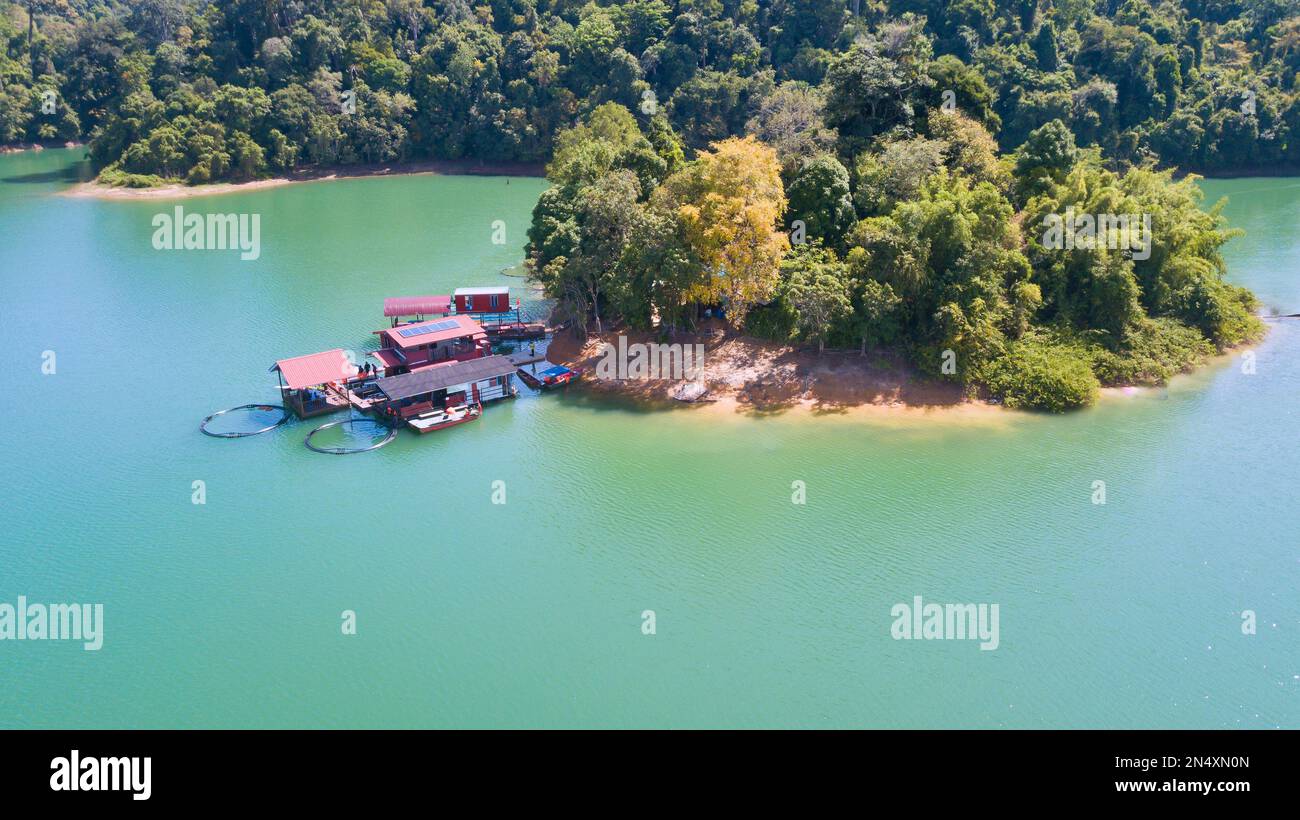 An aerial view of Pedu lake and boathouses beside the small island ...