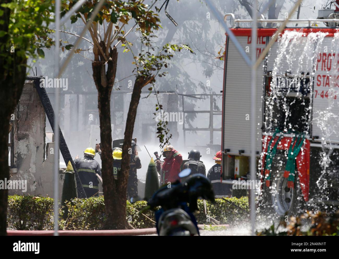 Firemen train their hose at the Explosives Ordnance Battalion barracks ...