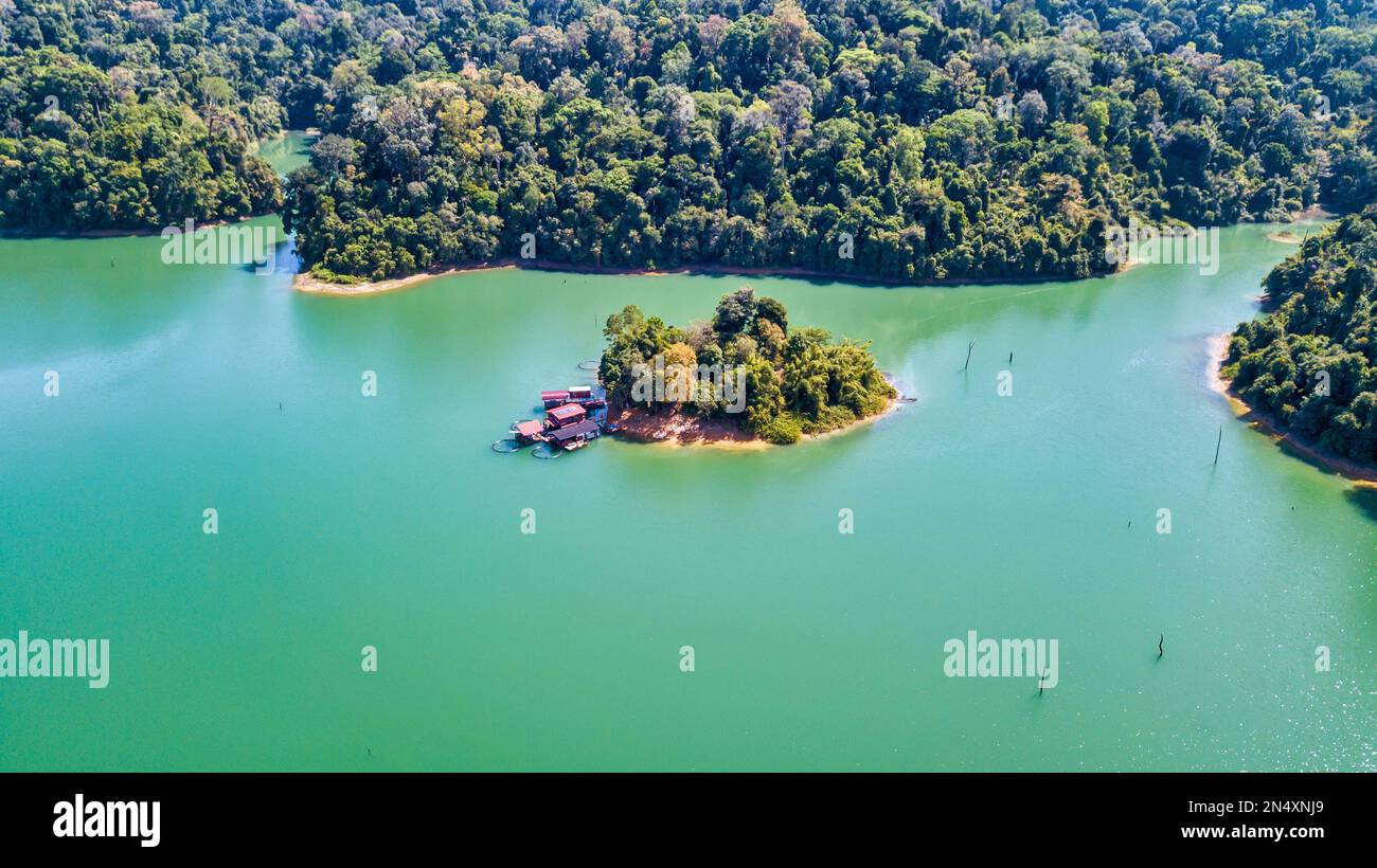 An aerial view of Pedu lake and boathouses beside the small island ...