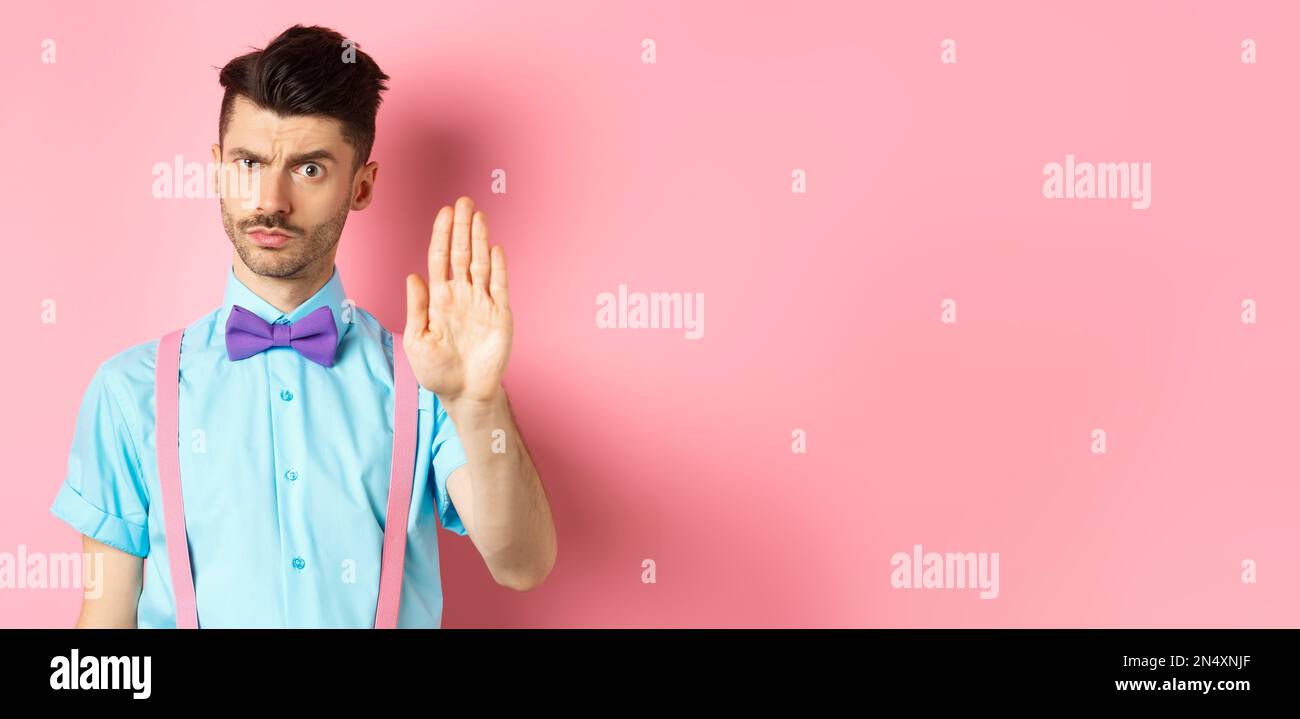 Serious-looking man prohibit something bad, stretch out hand to stop ...