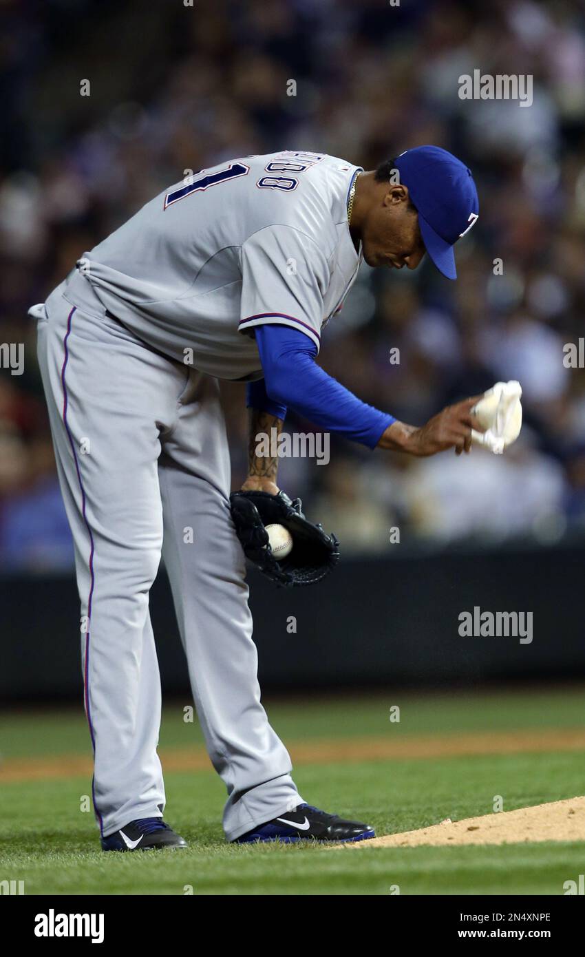 Texas Rangers relief pitcher Alexi Ogando reacts after giving up an RBI ...