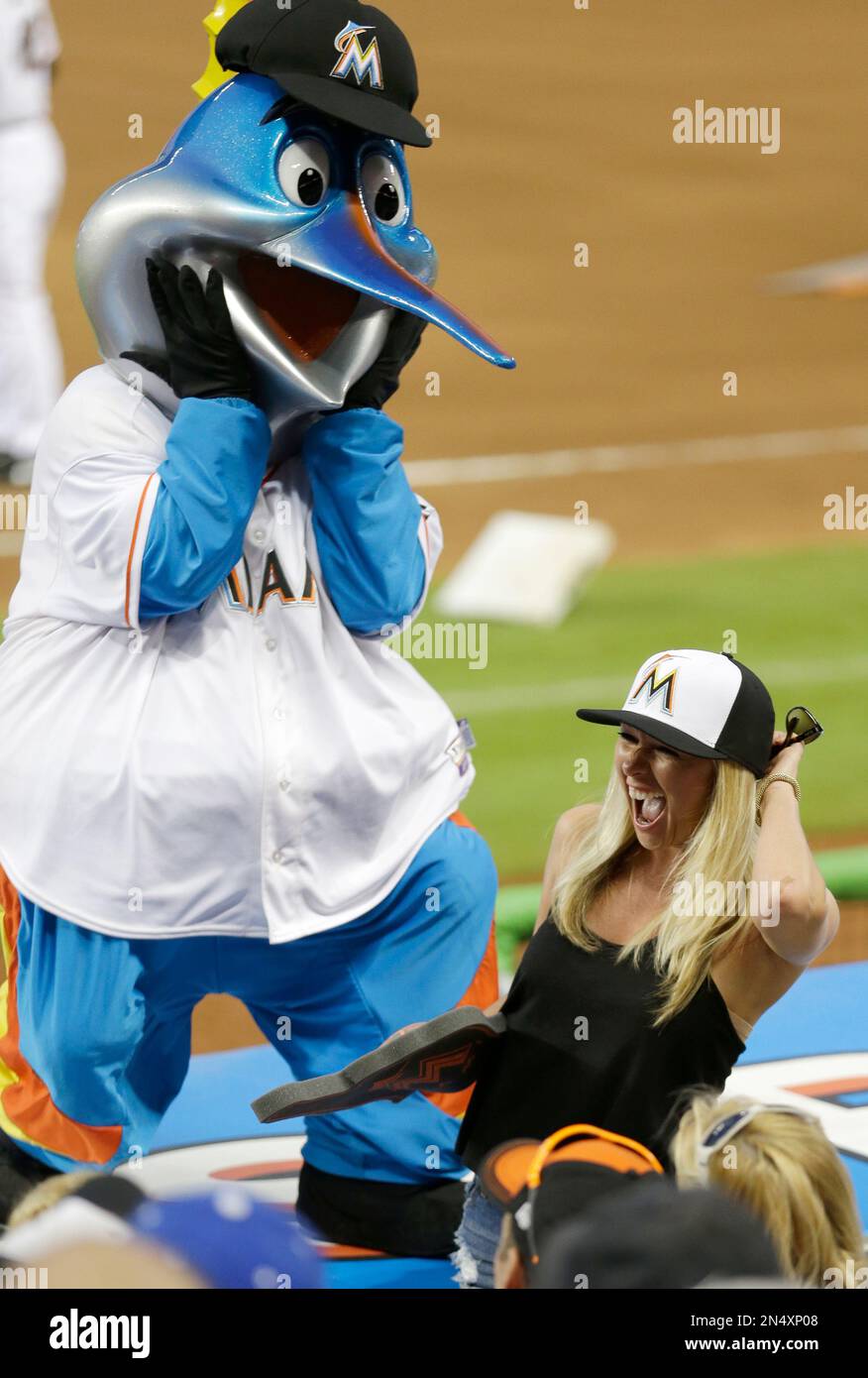 Miami Marlins mascot "Billy the Marlin," poses with a fan during the fourth inning of a baseball ...