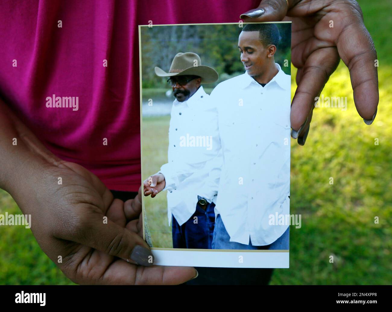A family friend holds a December 2013 family photograph of James ...