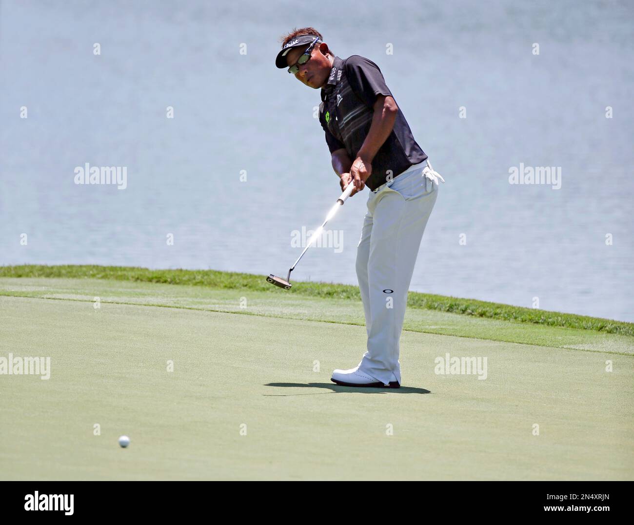 Thongchai Jaidee, of Thailand, putts on the 18th green during a ...