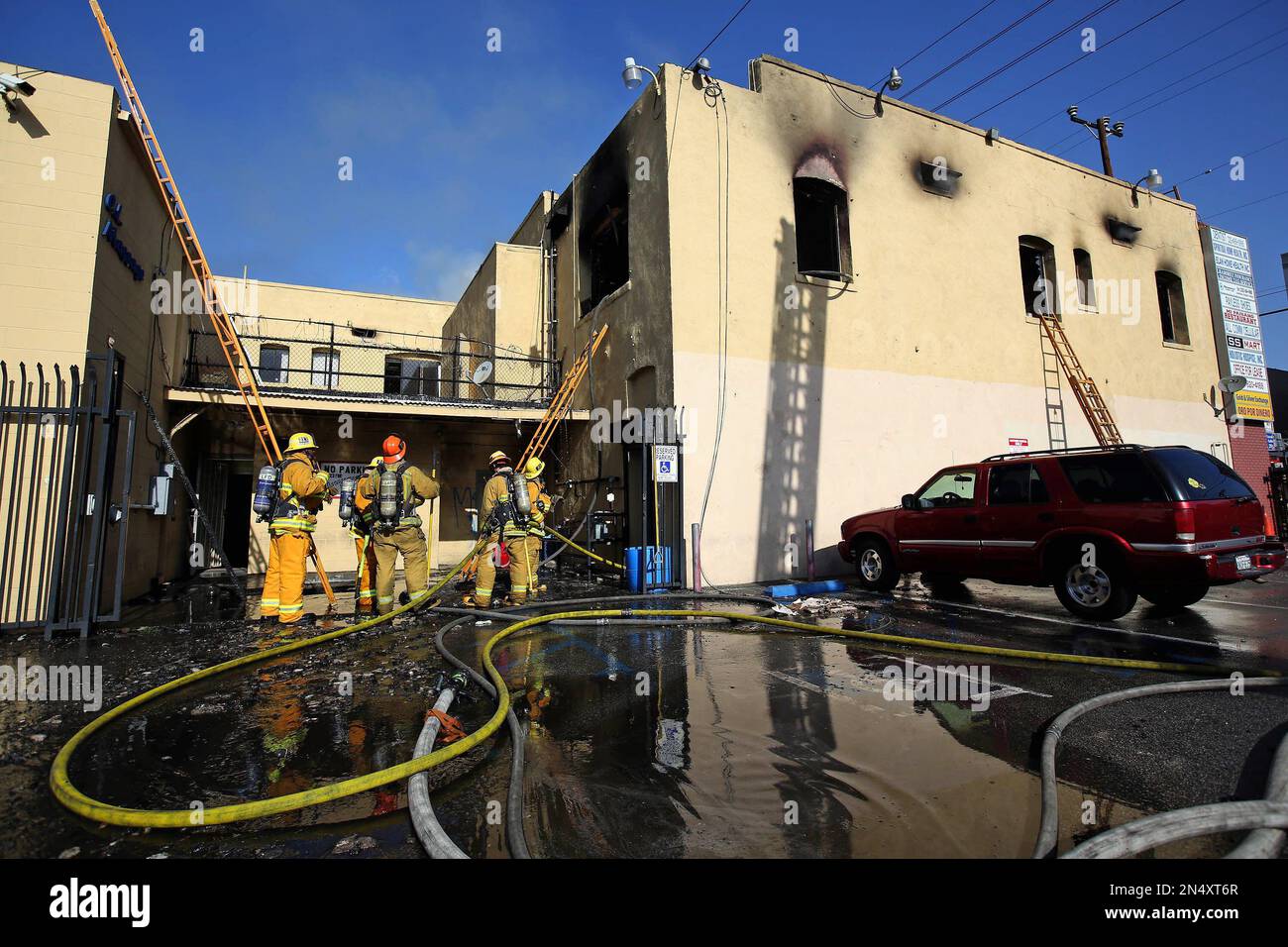Los Angeles firefighters look over a building fire in the Hollywood ...