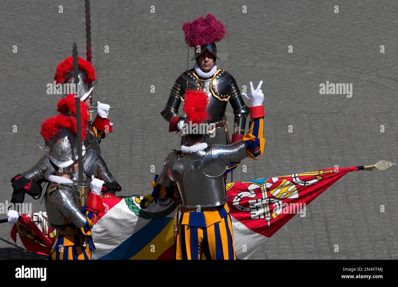 Vatican Swiss guards, one of them holding up his right arm and showing ...